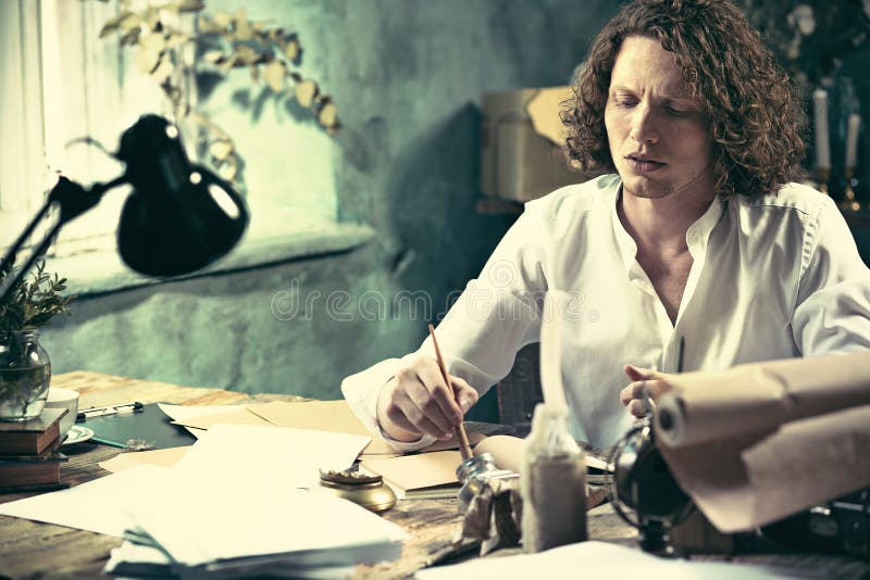 Writer at Work. Handsome Young Writer Sitting at the Table and Writing ...