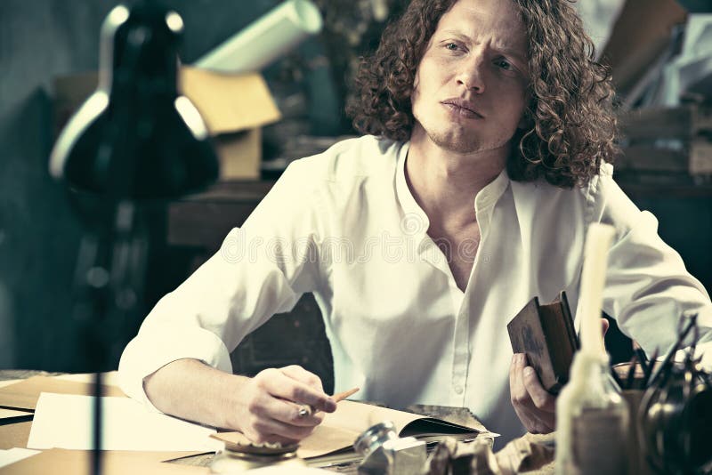 Writer at Work. Handsome Young Writer Sitting at the Table and Writing ...