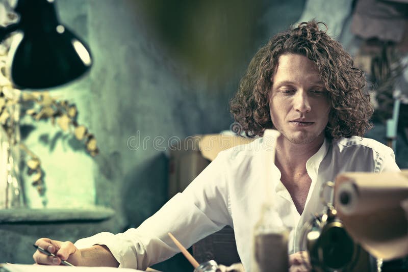 Writer at Work. Handsome Young Writer Sitting at the Table and Writing ...