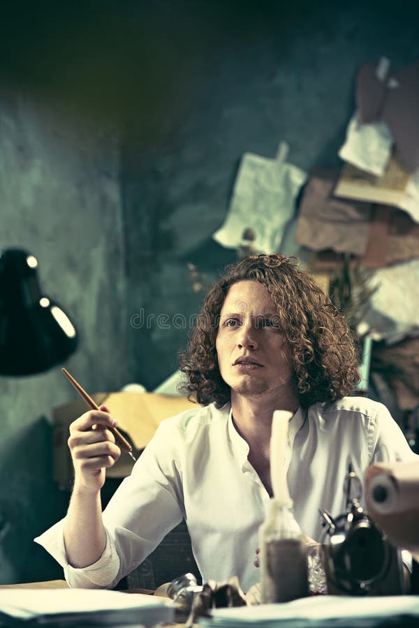 Writer at Work. Handsome Young Writer Sitting at the Table and Writing ...
