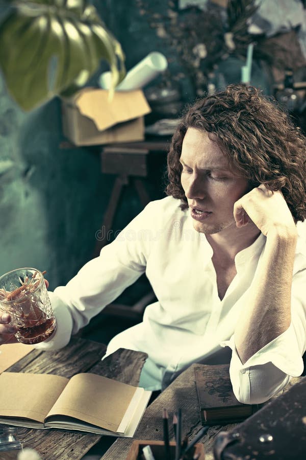 Writer at Work. Handsome Young Writer Sitting at the Table and Writing ...