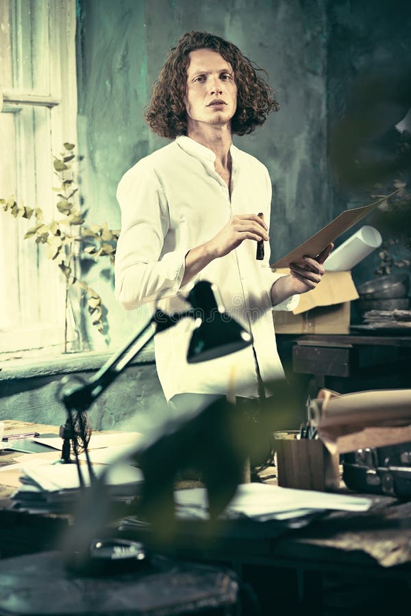 Writer at Work. Handsome Young Writer Standing Near the Table and ...