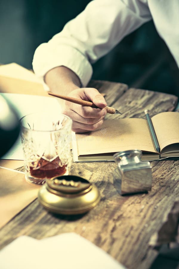 Writer at Work. Handsome Young Writer Sitting at the Table and Writing ...