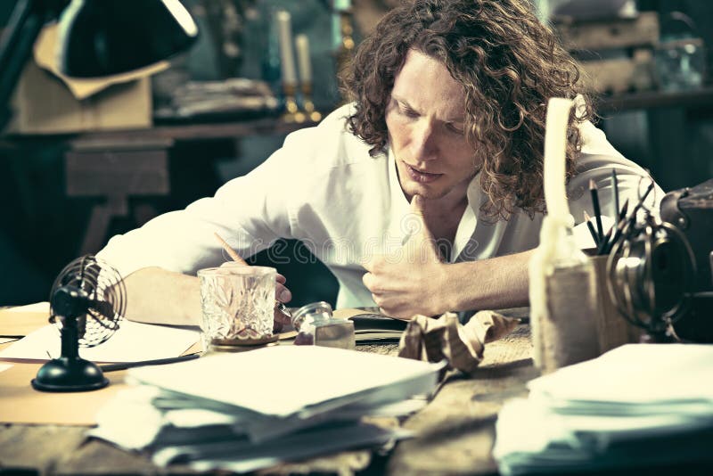 Writer at Work. Handsome Young Writer Sitting at the Table and Writing ...