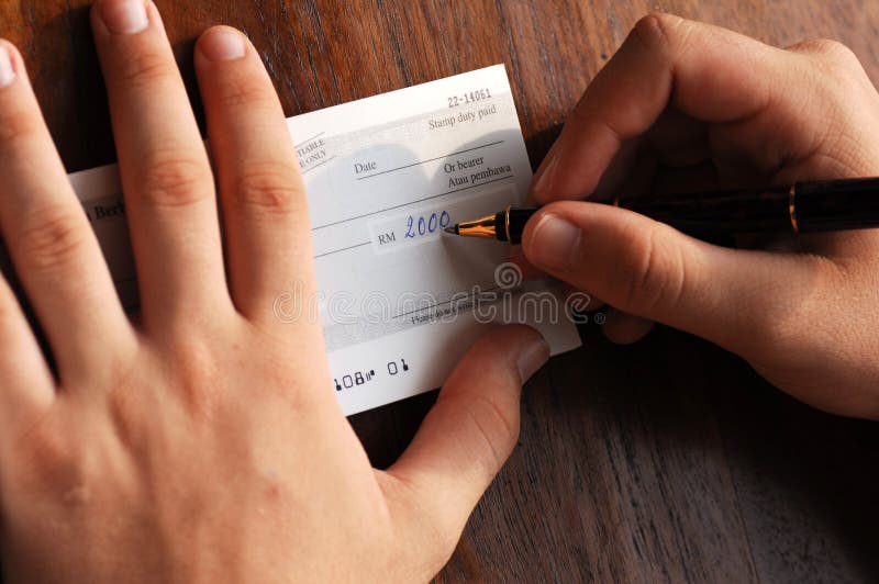 Writing a check stock image. Image of holding, checkbook - 5804419