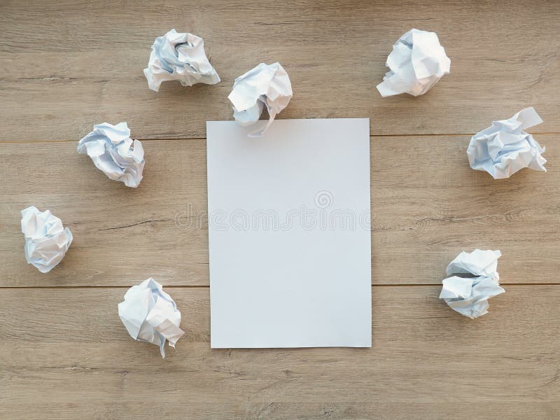 Writing Concept - Crumpled Up Paper Wads with a Sheet of White Paper ...