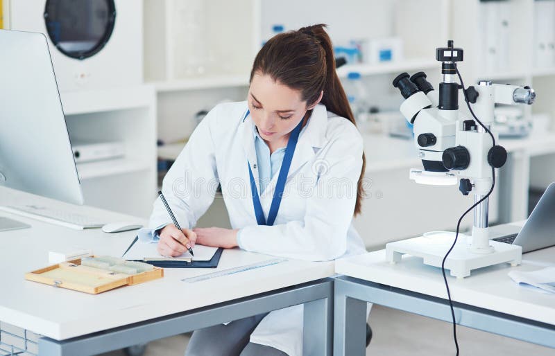 Writing Down My Findings. a Focused Young Female Scientist Making Notes ...