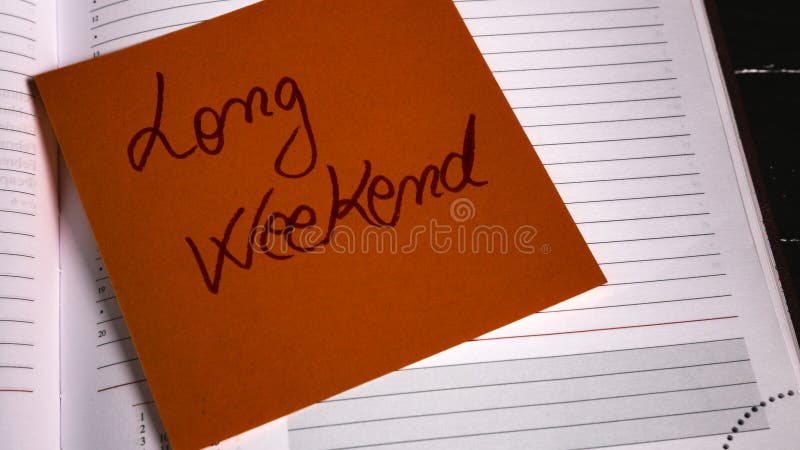 Writing Long Weekend on Memo Post Reminder. Text Long Weekend on Sticky ...