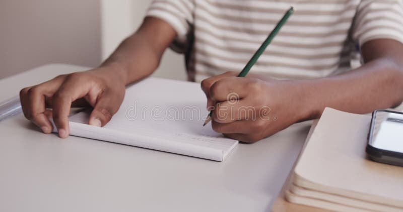 Writing in Notebook, Student Focusing on Schoolwork at Desk in ...