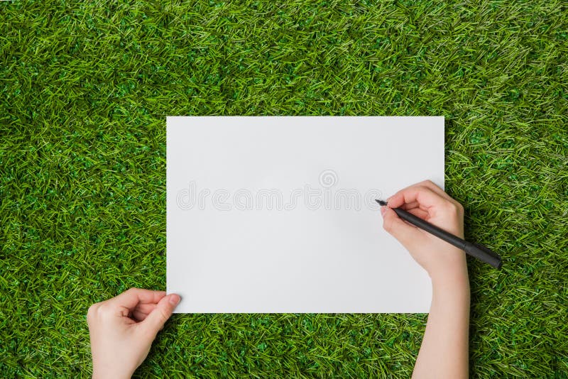 Writing on Sheet of Paper Over Grass Close Up Stock Image - Image of ...