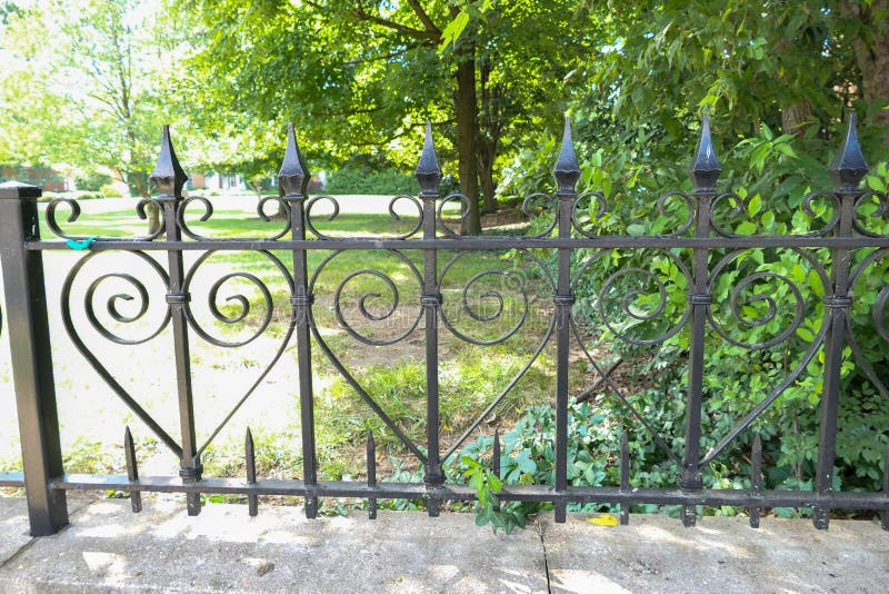 A Wrought Iron Fence with Heart Motif Stock Photo - Image of spiral ...