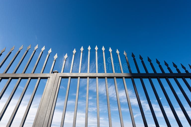 Wrought Iron Gate with Sharp Points on Blue Sky with Clouds Stock Photo ...