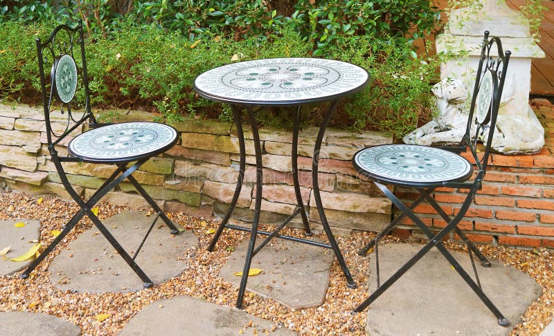 Wrought Iron Tea Table and Chairs in Garden Stock Photo - Image of iron ...