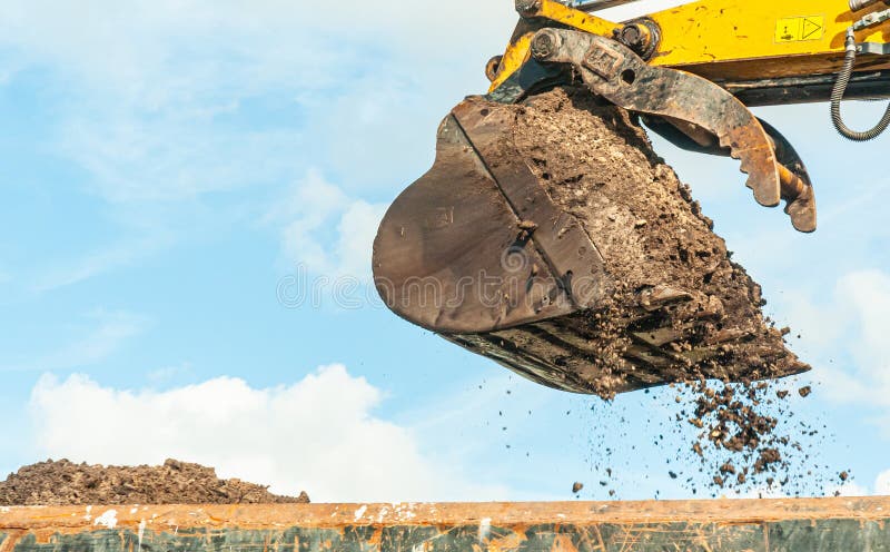 A 4x4 Backhoe Loader with a Full Bucket of Dirt, Ready To Dump into ...