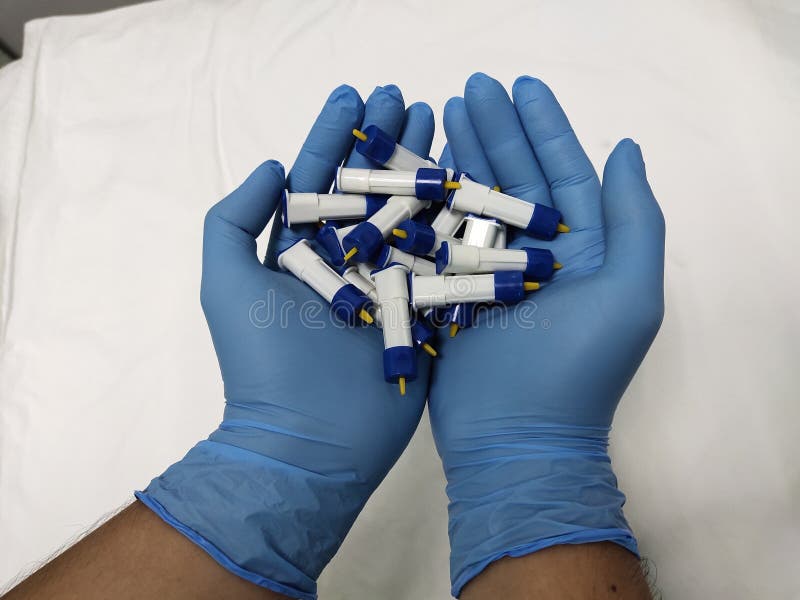 & X22;Gloved Hands Holding Multiple Small Lancets for Capillary Blood ...