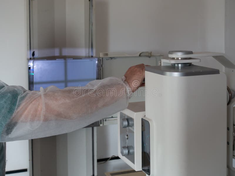 An X-ray Technician Prepares the X-ray Machine for Work. Stock Photo ...