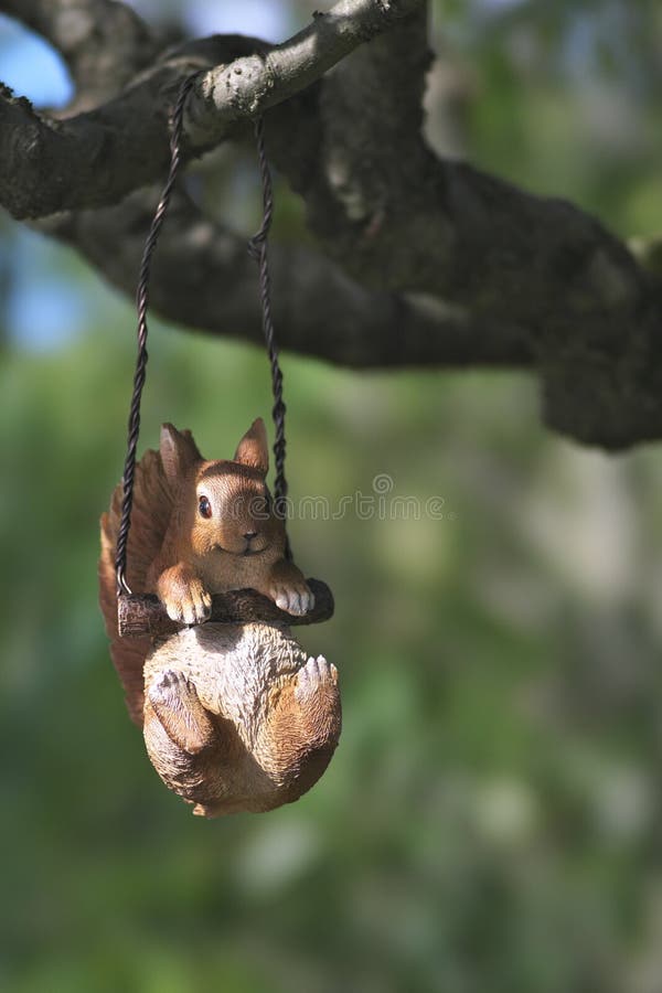 A squirrel doll on a swing stock photo. Image of green - 256514100