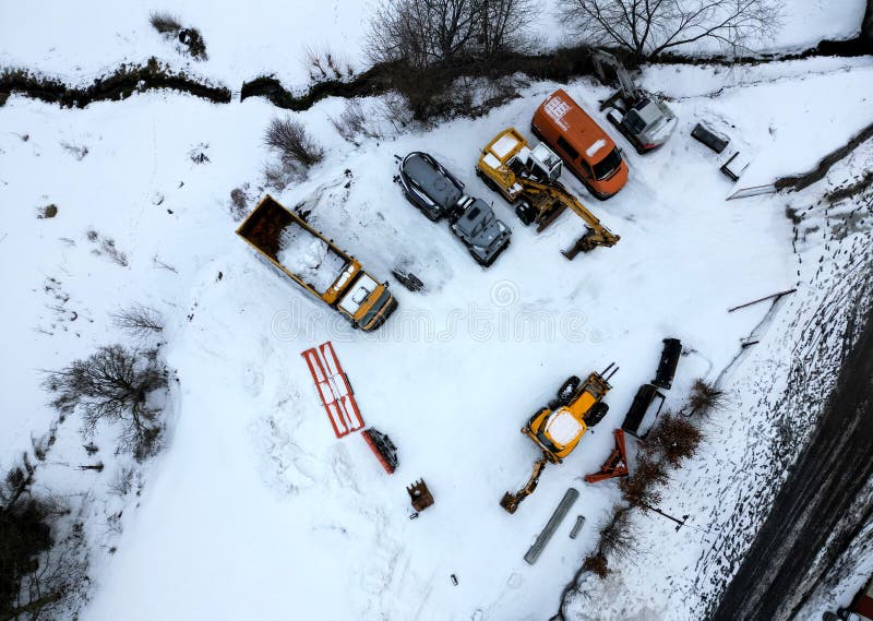 The Yard with Construction Equipment is Covered in Snow and Most of ...