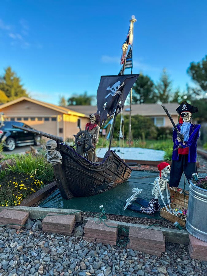 A Yard Has Halloween Decorations that Include a Pirate Ship, Pirate and ...