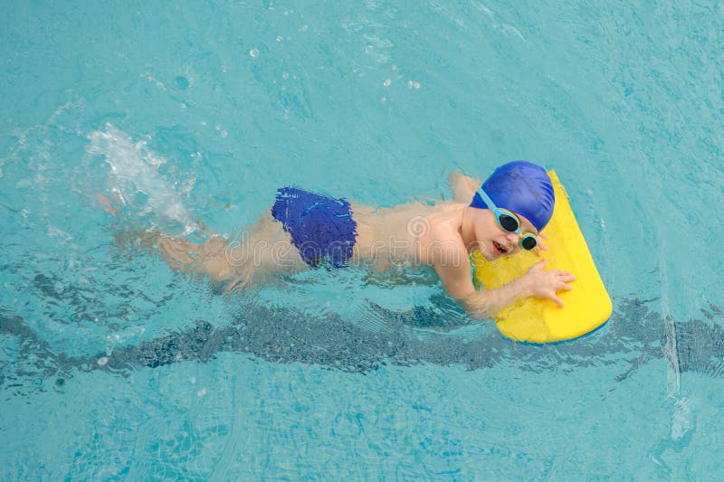 7-year Boy Swimming Backstroke in a Swimming Pool Stock Photo - Image ...