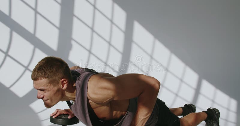 Athletic Young Man Performing Push-Ups in a Studio with Shadows Stock ...