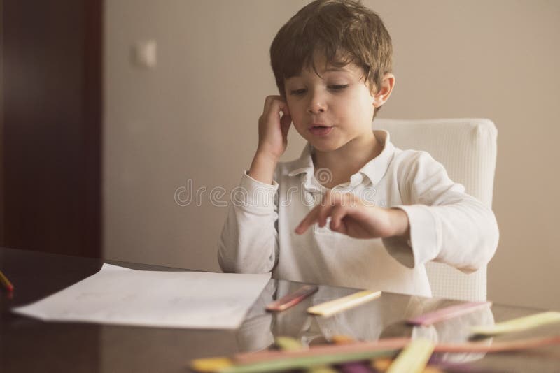 4-year-old Boy Does Homework at Home.he Does Addition and Subtraction ...