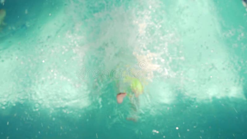6 Year Old Boy Falling into the Pool with Blue Water. Splashes Fly in ...