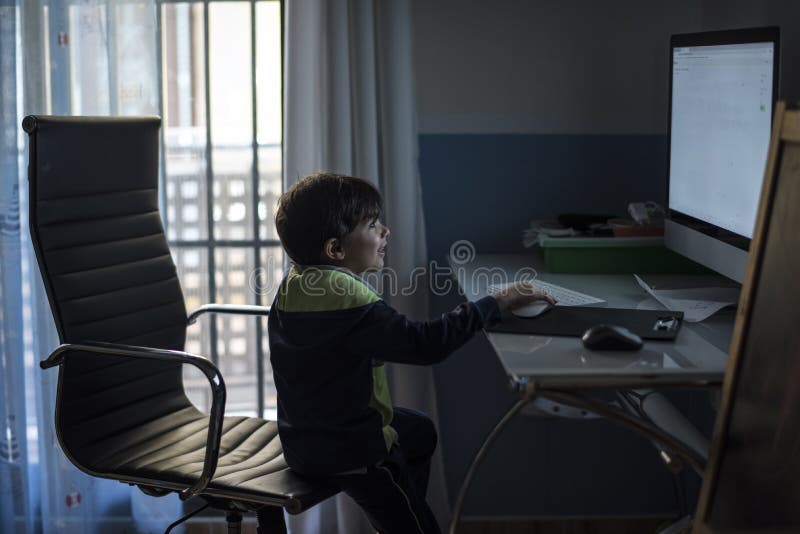 4 Year Old Boy Handles the Computer in a Dark Environment at Home Stock ...