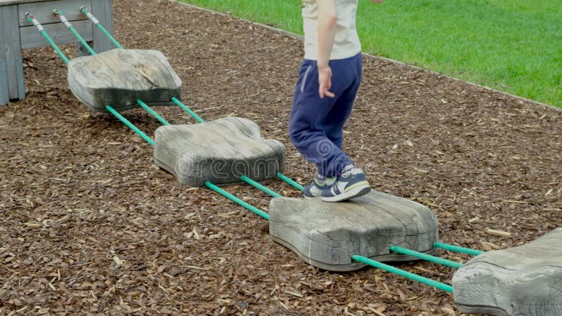 A 5-year-old Boy Plays on the Playground, Develops Balance Stock Video ...