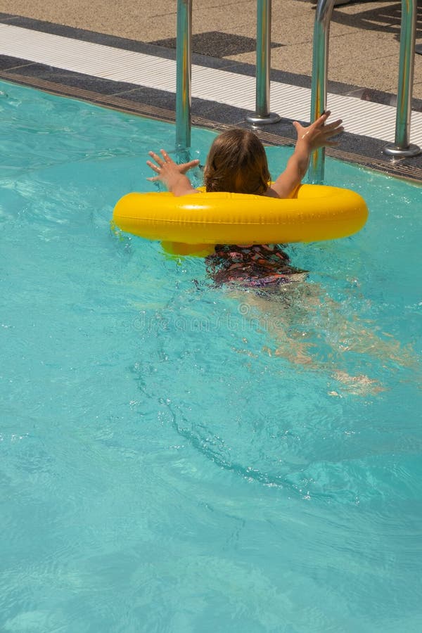 A 5-year-old Girl Swims in a Pool with an Inflatable Circle Stock Photo ...