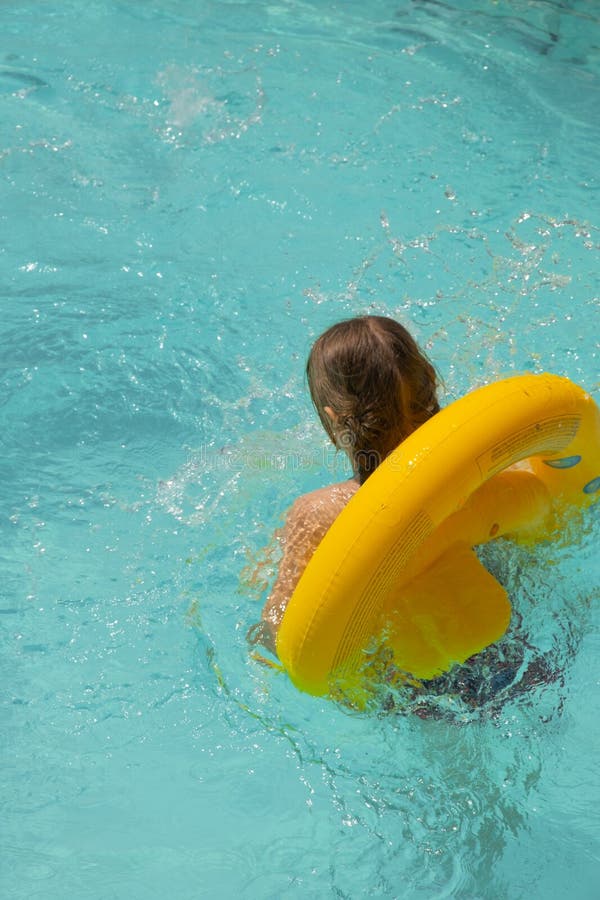 A 5-year-old Girl Swims in a Pool with an Inflatable Circle Stock Photo ...