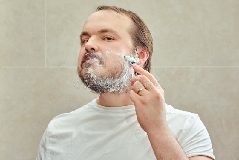 A 35-40 Year Old Man Shaves His Beard with a Safety Razor, Lifestyle ... A 35-40 Year Old Man Shaves His Beard with a Safety Razor, Lifestyle ...
