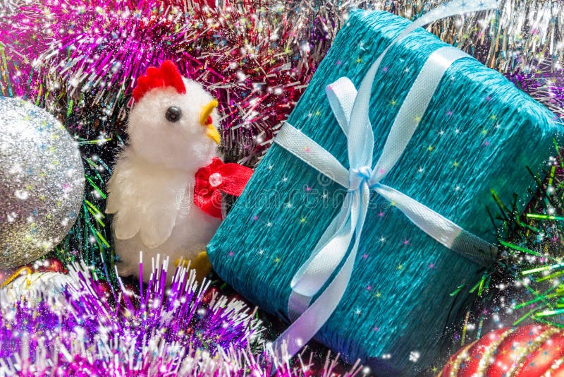 Year of the Rooster. Chicken and Gift Box among the Tinsel Stock Image ...