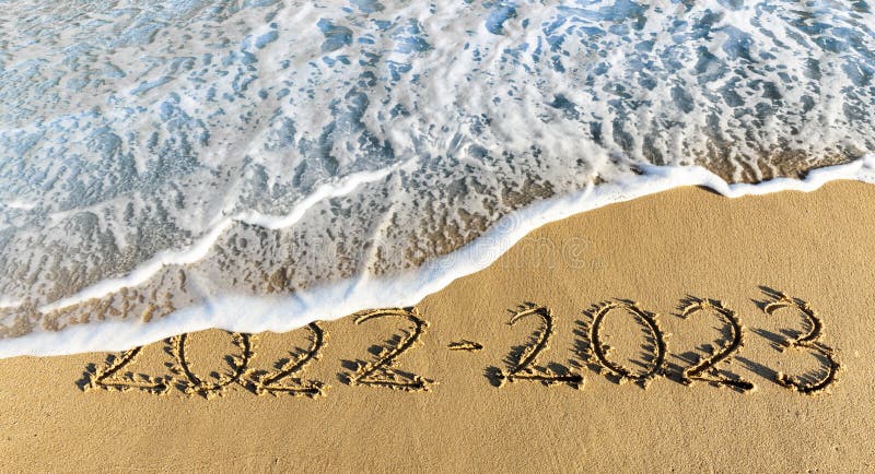 Year 2023 written in sand stock image. Image of sand - 261017875
