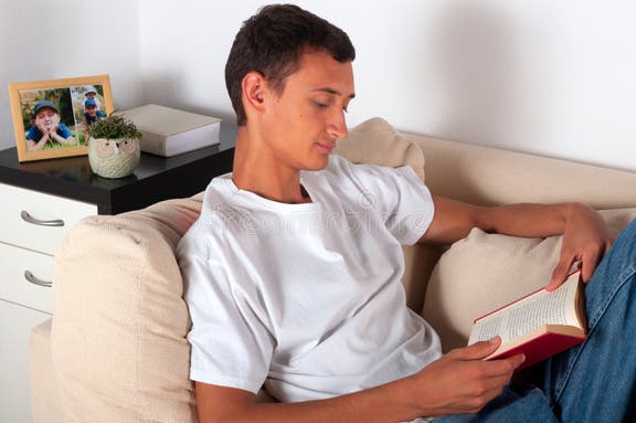18-years Guy Reading Book on Sofa at Home Stock Image - Image of ...