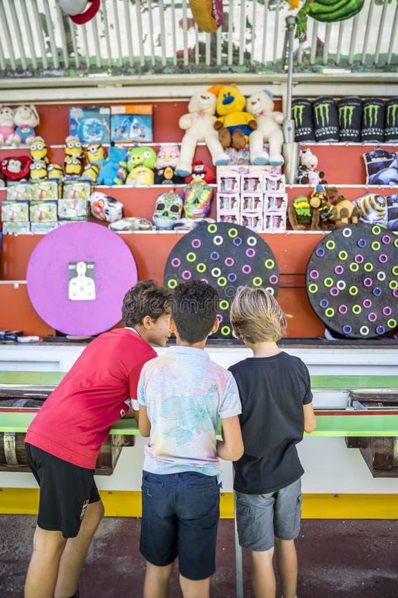 8 Years Old Children Looking at a Shooting Range in a Funfair Editorial ...