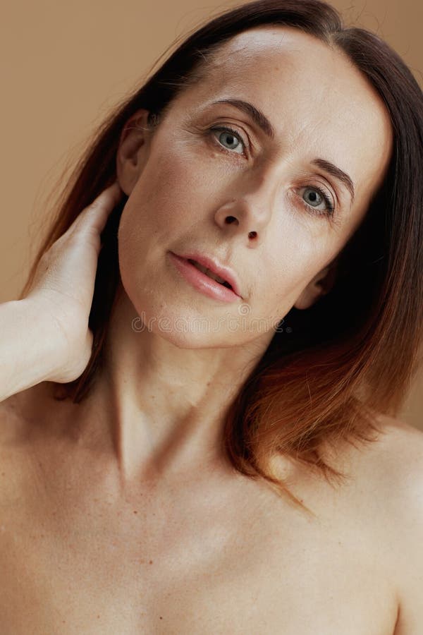 40 Years Old Woman In Shirt Isolated On Beige Background Stock Image
