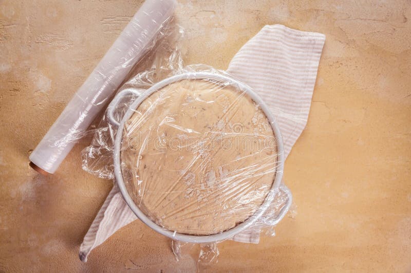 Yeast Dough Covered by Plastic Wrap, Proofed Dough for Baking Bread or ...