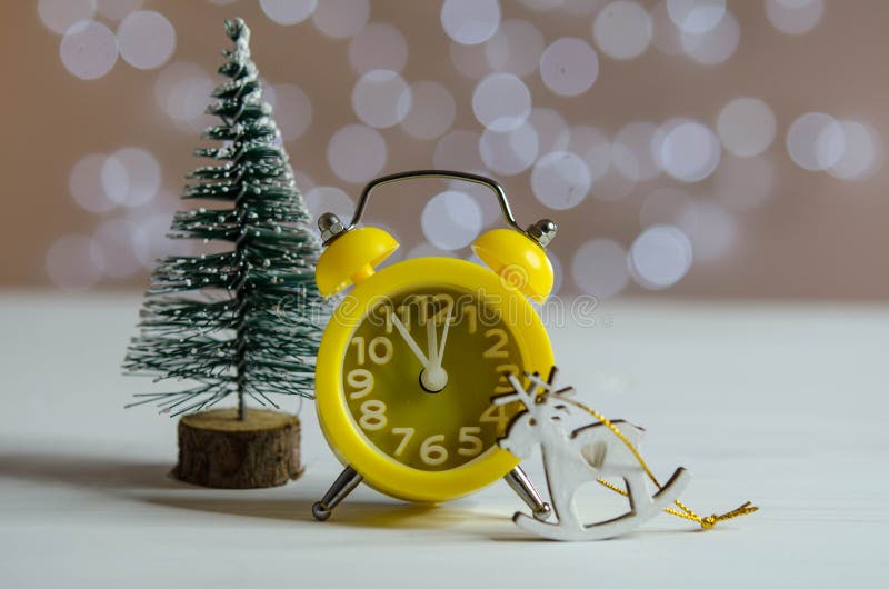 Yellow Alarm Clock and a Christmas Tree on the Table Stock Image ...