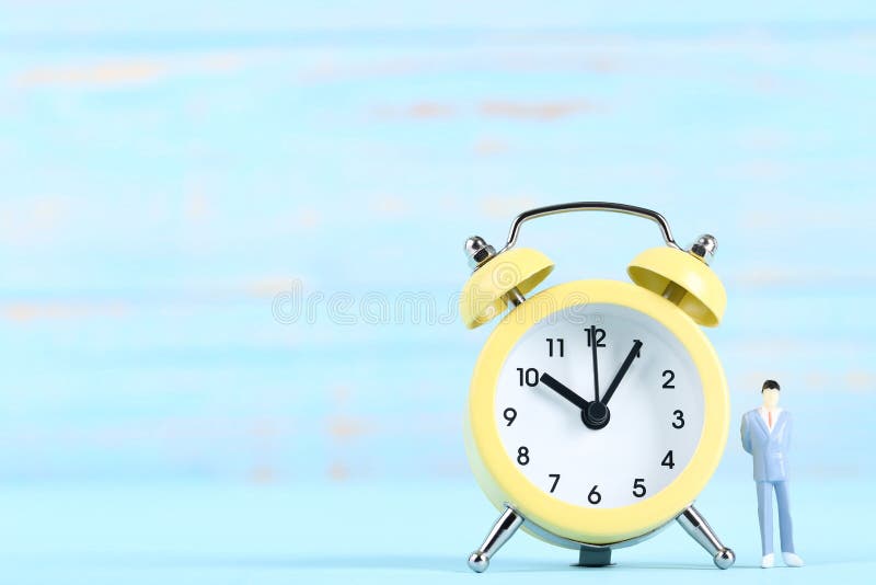 Yellow Alarm Clock with Human Figure Stock Photo - Image of alarm ...