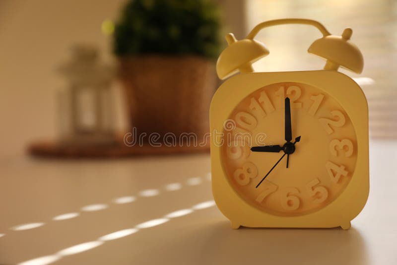 Yellow Alarm Clock on Table Indoors. Space for Text Stock Photo - Image ...