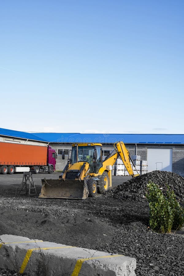 The Yellow All-wheel Drive Backhoe Loader Stands on the Yard Ready for ...