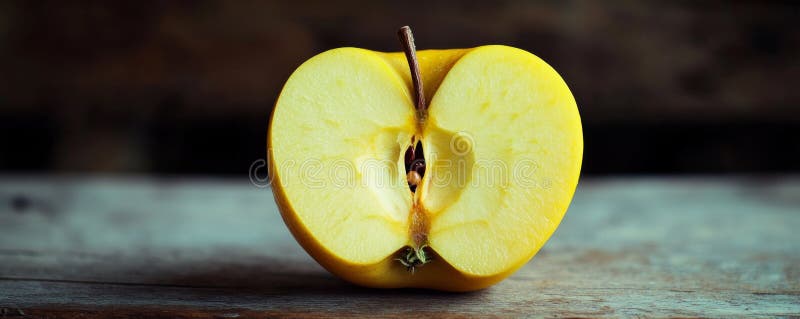 Yellow Apple Cut in Half on Wooden Surface Stock Photo - Image of ...