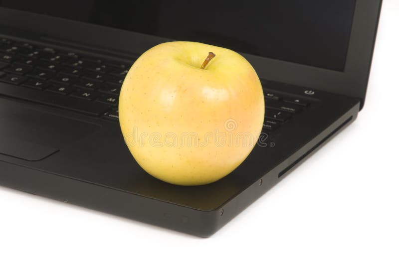 Yellow Apple on Laptop stock photo. Image of eating, fresh - 40016468