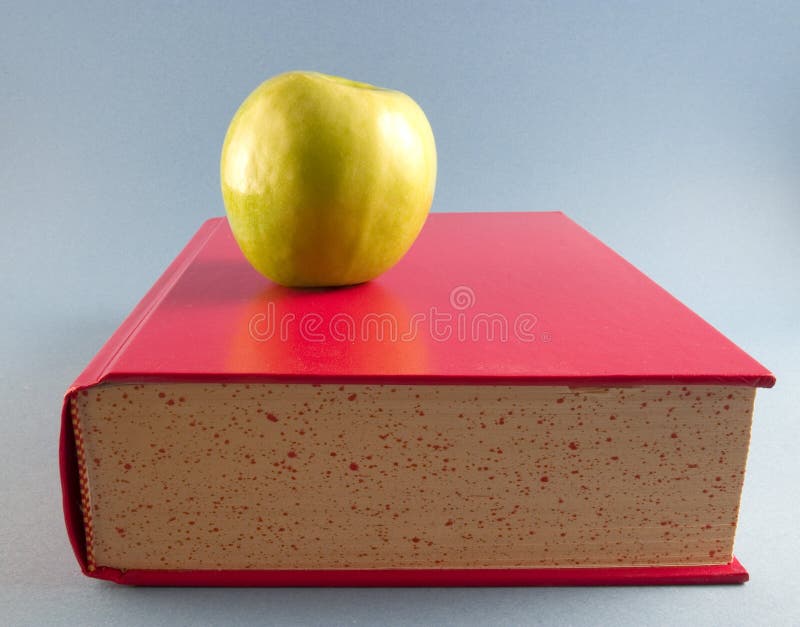 Yellow apple with red book stock photo. Image of education - 3388728