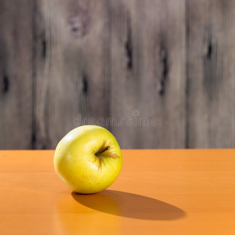 Yellow apple on the table stock photo. Image of eating - 83799020