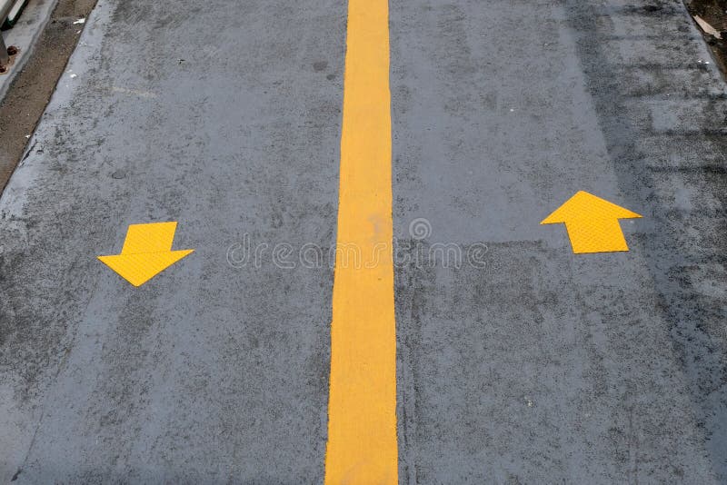 Yellow Arrow Painted in a Pathway. Directional Sign Stock Photo - Image ...