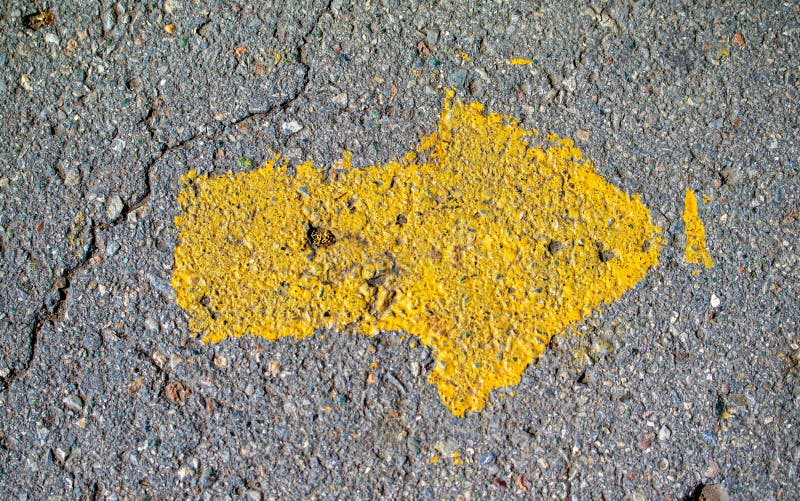 Yellow Arrow on the Pavement Stock Photo - Image of surface, track ...