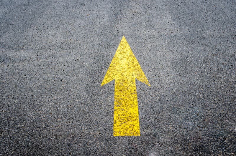 Yellow Arrow on Pavement Pointing Ahead Stock Image - Image of arrow ...