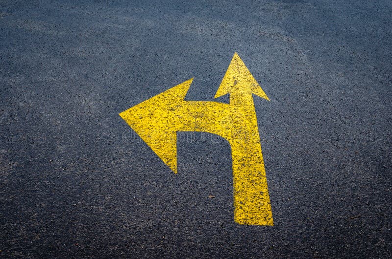 Yellow Arrow on Pavement Pointing Ahead and Left Stock Image - Image of ...